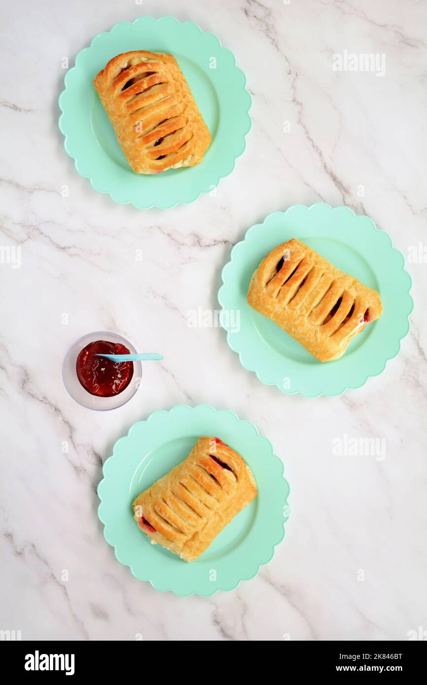 Fresh baked strawberry and cream cheese croissants on aqua petal plates ...