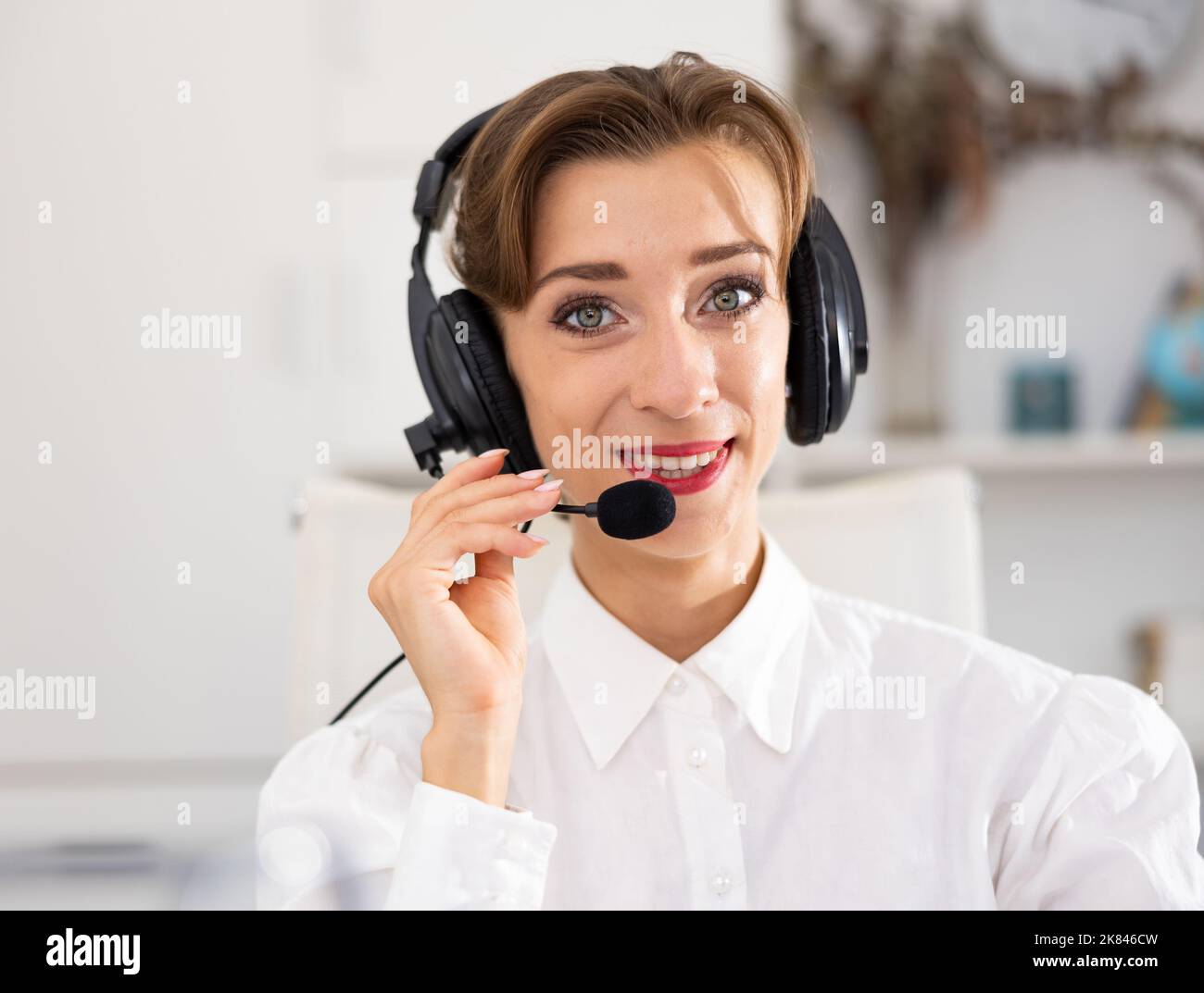 Call center operator talking with client and smiling Stock Photo - Alamy