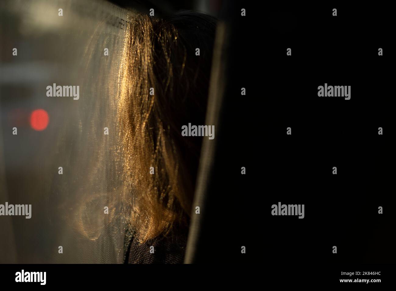 Girl sits by glass on bus. Hair for girl by window. Inside bus ...