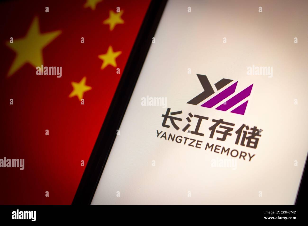 Yangtze Memory Technologies Corp logo on iPhone on Chinese flag in dark ...