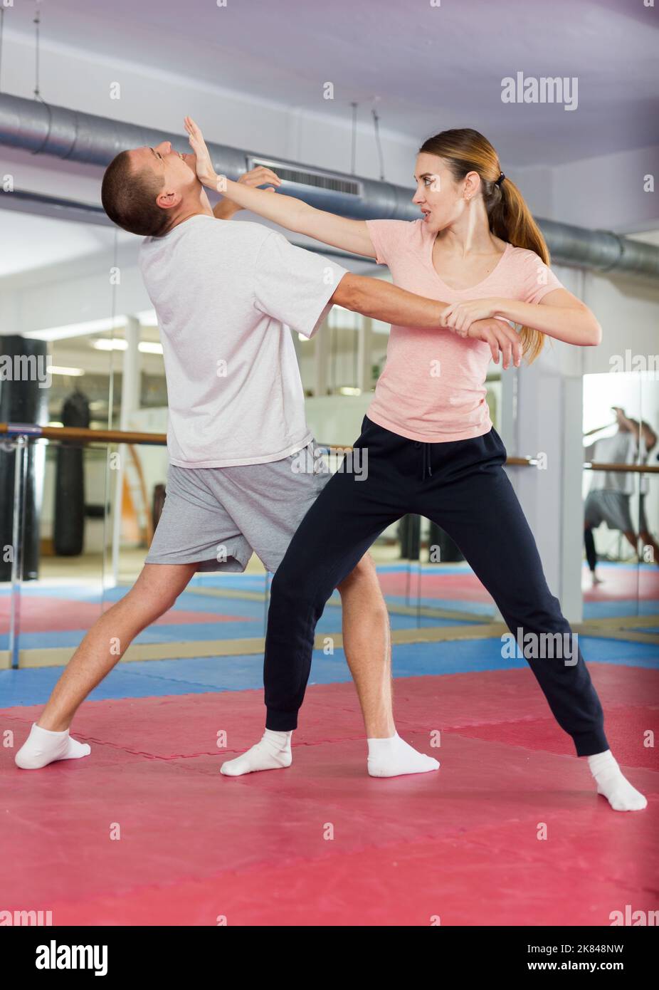 Woman learning chin strike move during self-defense training Stock ...
