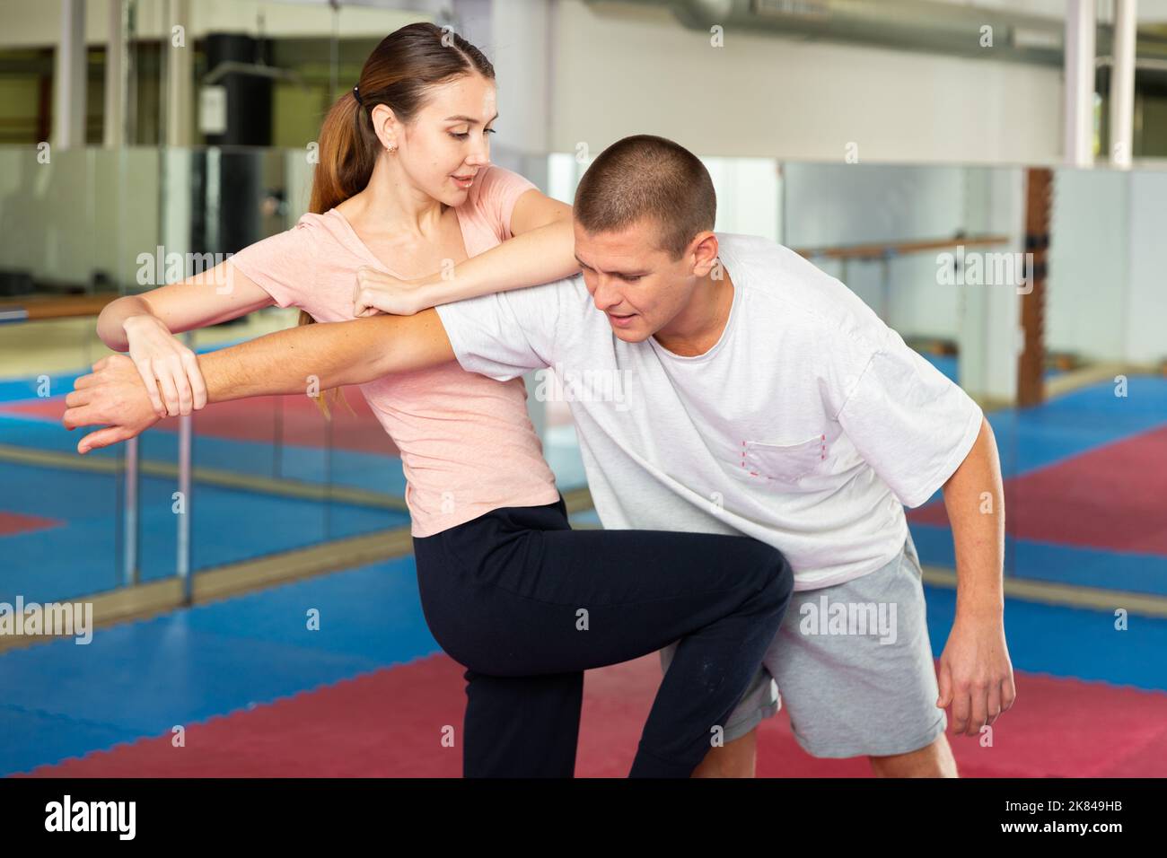Woman performing knee strike during self-defence training Stock Photo ...
