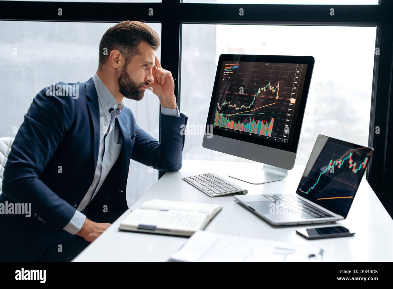 Focused clever successful caucasian male stock investor, broker, sit at ...