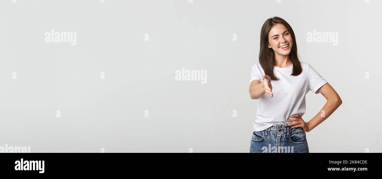 Smiling confident young woman extend hand for handshake, greeting ...