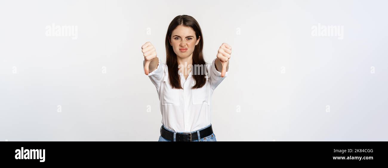 Disappointed adult corporate woman showing thubms down, dislike gesture ...