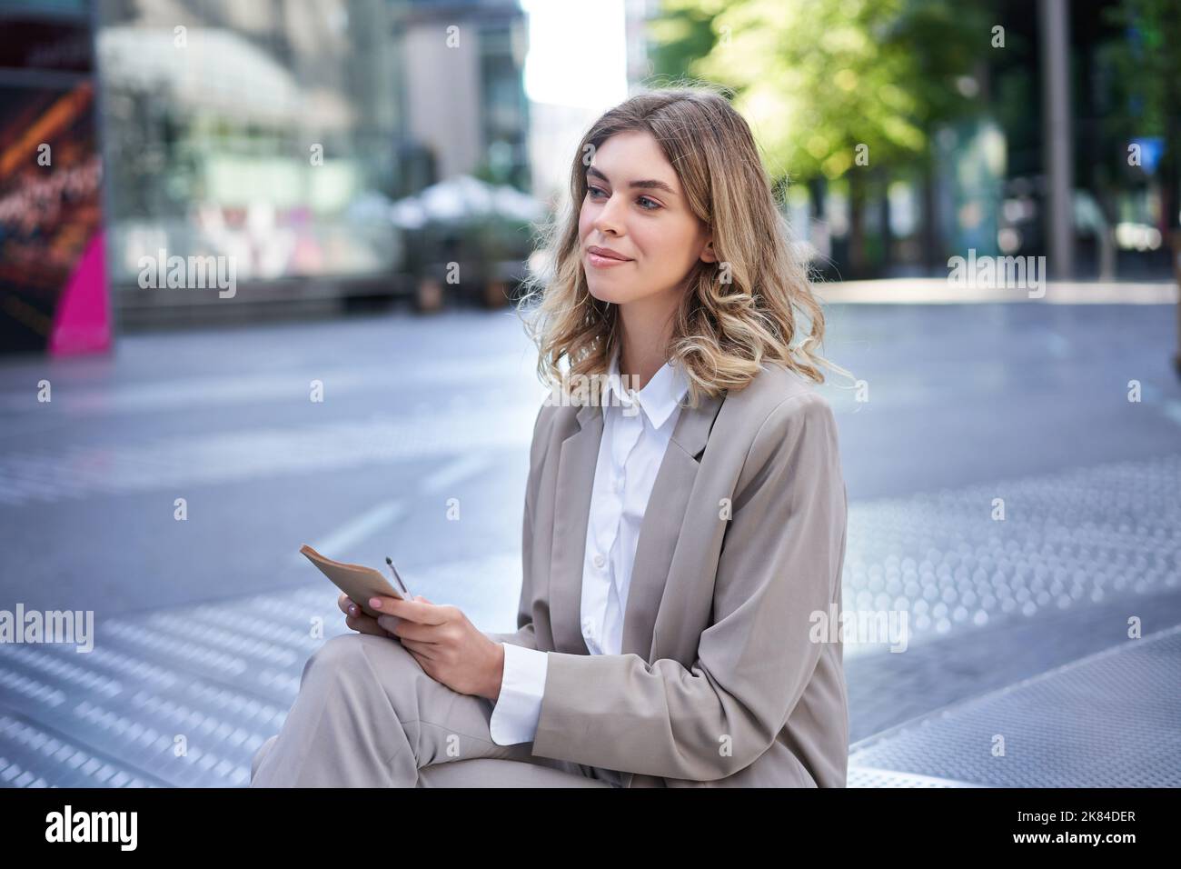 Young businesswoman preparing for speech, interview in company, writing ...