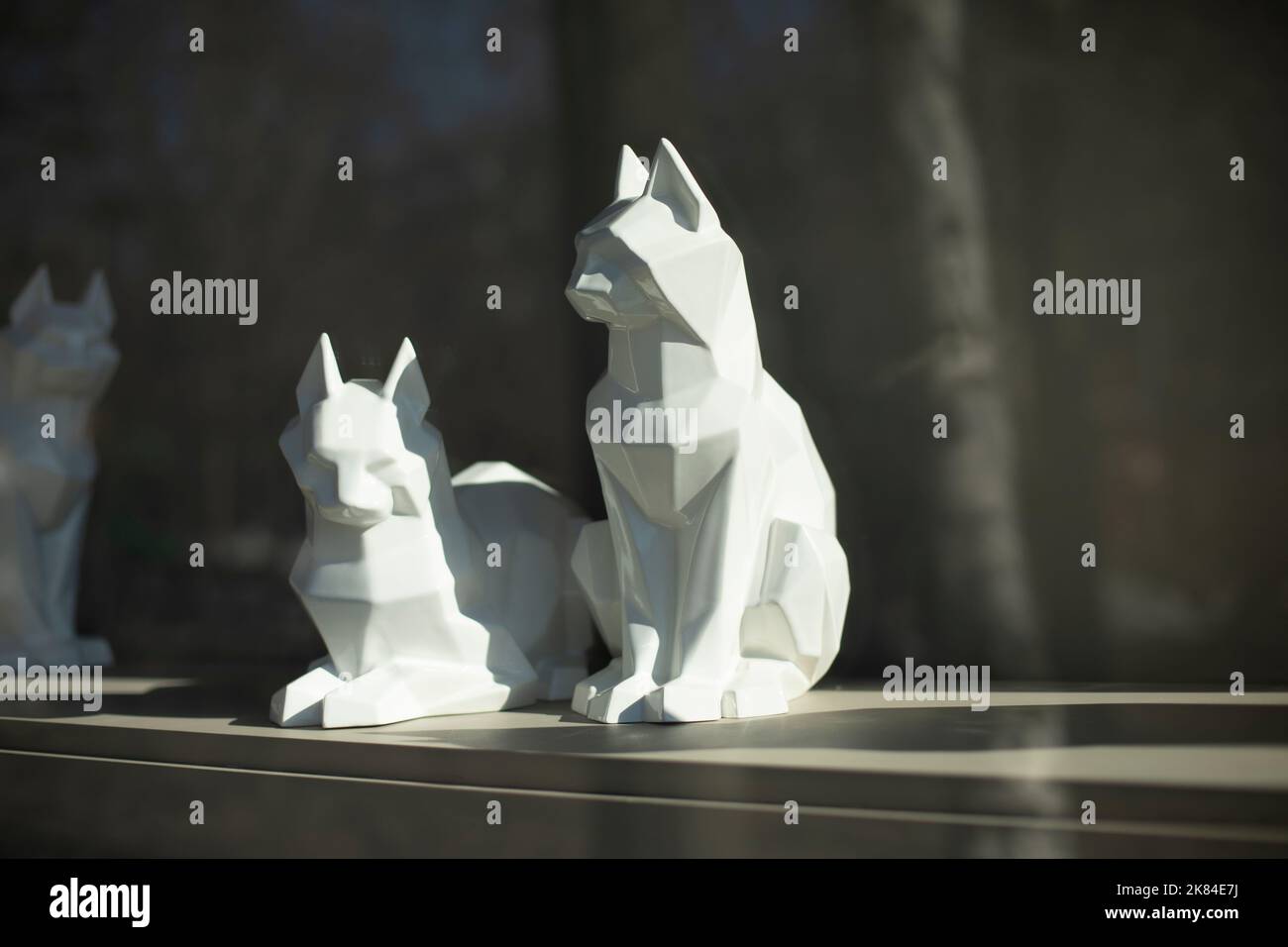 Cubic figures of cats. Sculpture of white cat. Interior item. Light ...