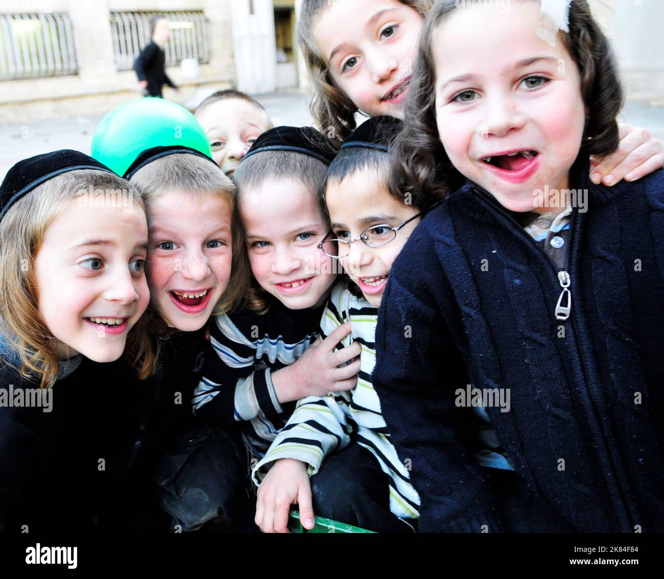 Cheerful & happy. Orthodox Jewish boys having fun in the courtyard of ...