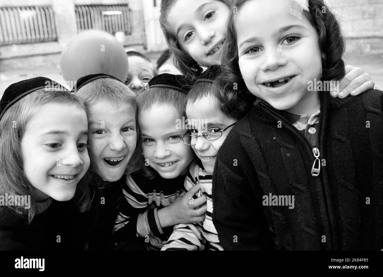 Cheerful & happy. Orthodox Jewish boys having fun in the courtyard of ...
