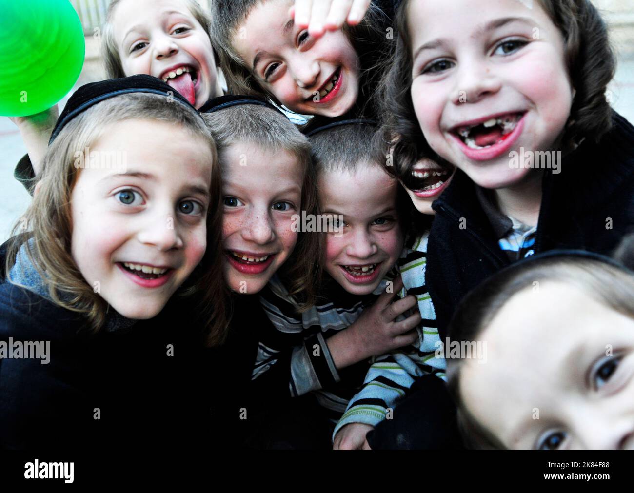 Cheerful & happy. Orthodox Jewish boys having fun in the courtyard of ...