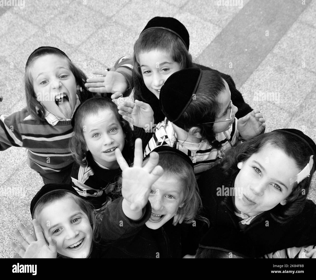 Cheerful & happy. Orthodox Jewish boys having fun in the courtyard of ...