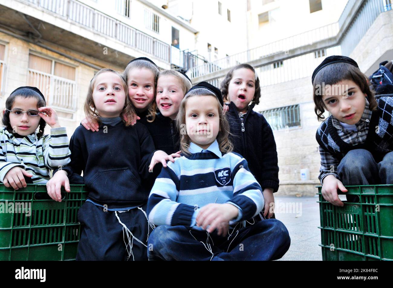 Cheerful & happy. Orthodox Jewish boys having fun in the courtyard of ...