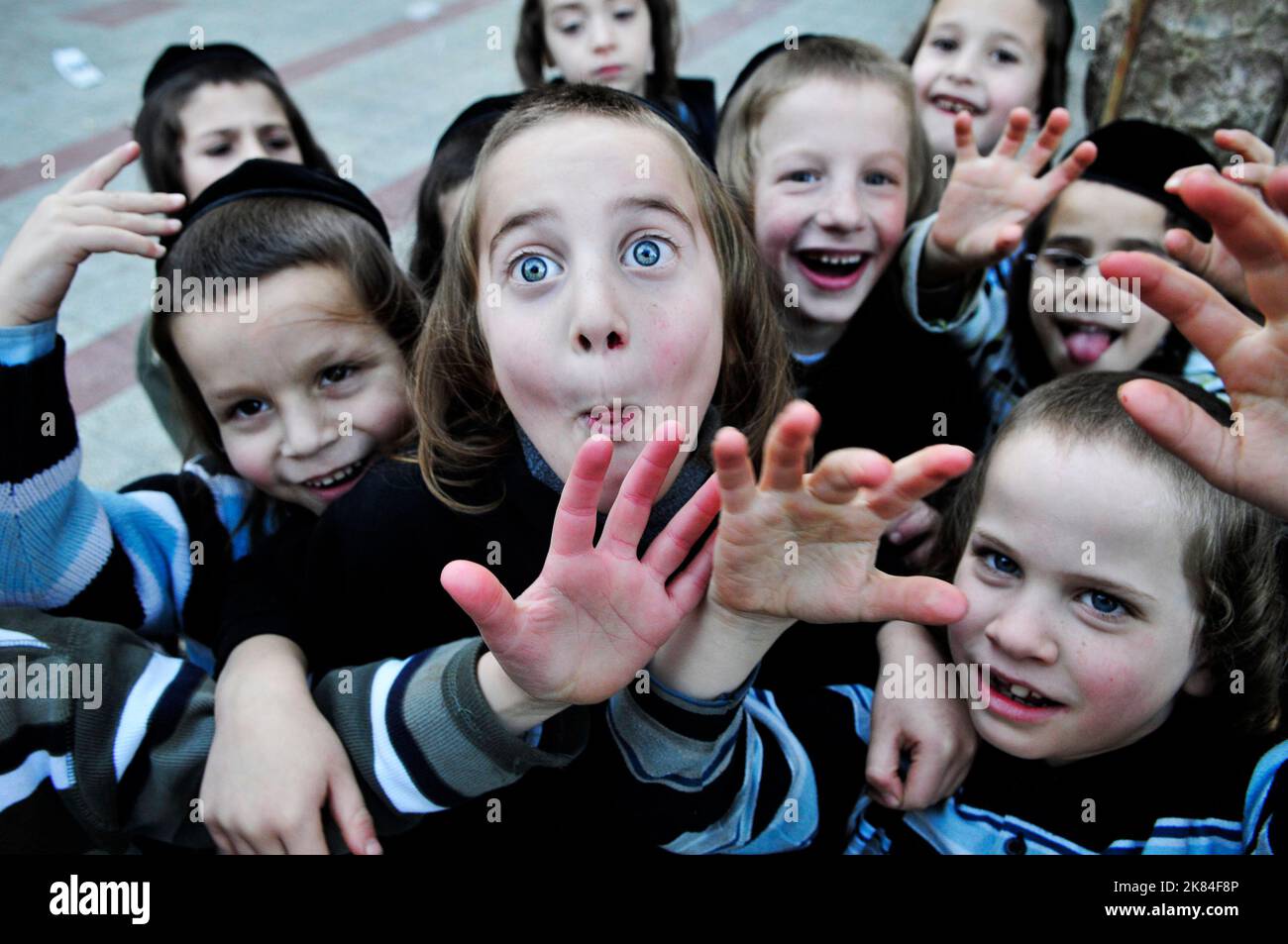 Cheerful & happy. Orthodox Jewish boys having fun in the courtyard of ...