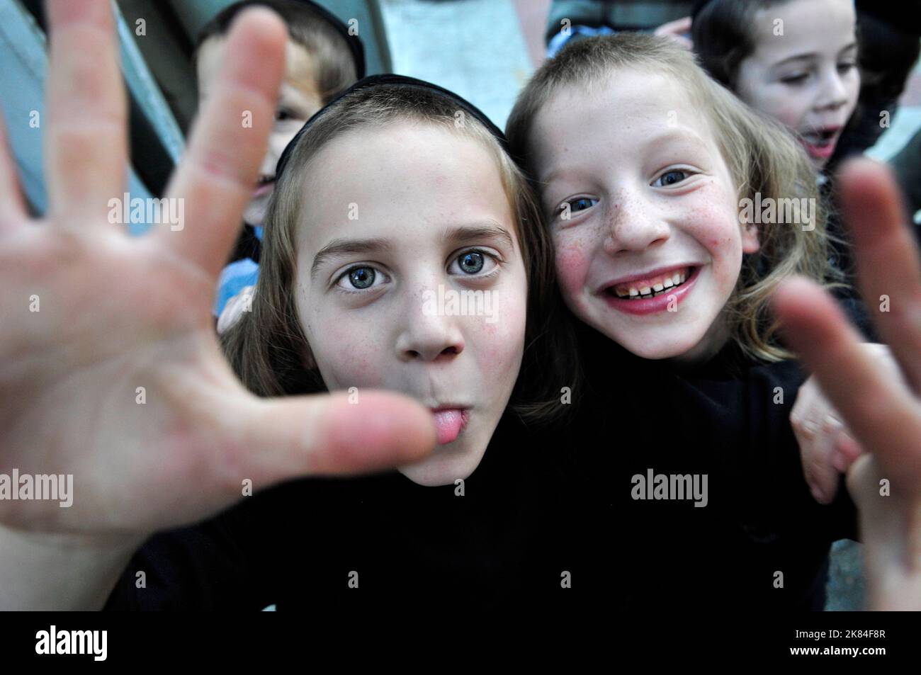 Cheerful & happy. Orthodox Jewish boys having fun in the courtyard of ...