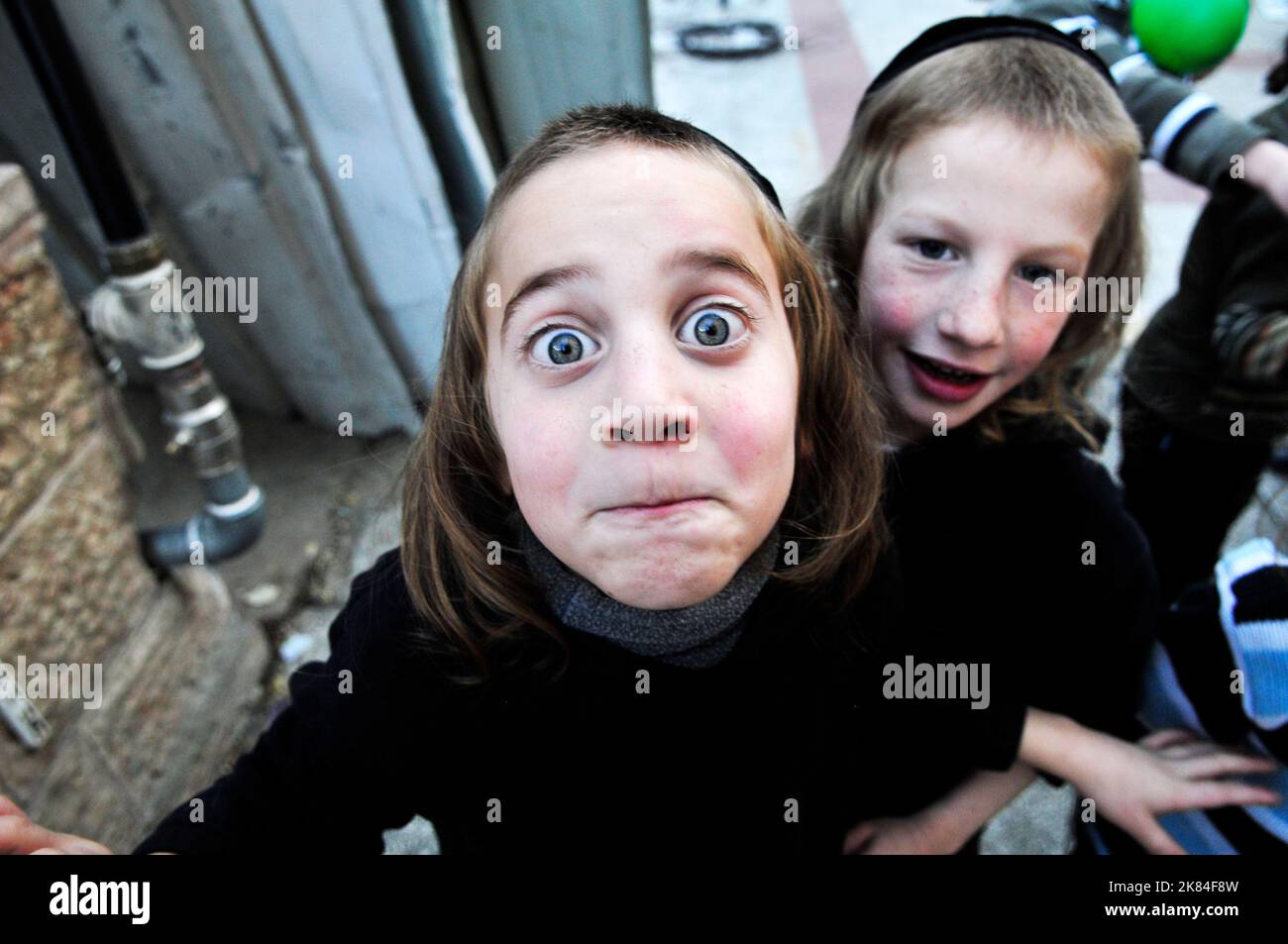 Cheerful & happy. Orthodox Jewish boys having fun in the courtyard of ...