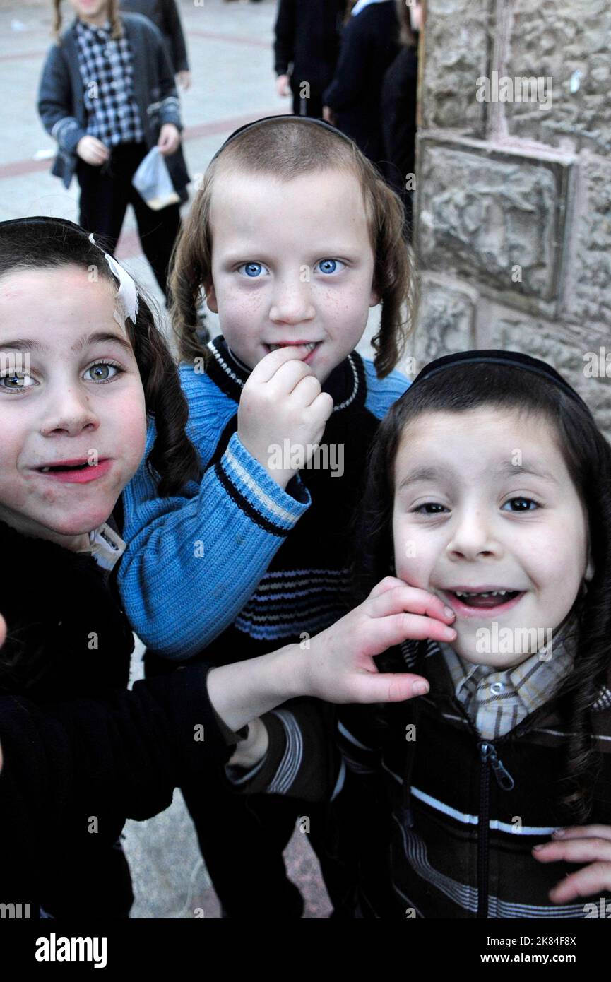 Cheerful & happy. Orthodox Jewish boys having fun in the courtyard of ...