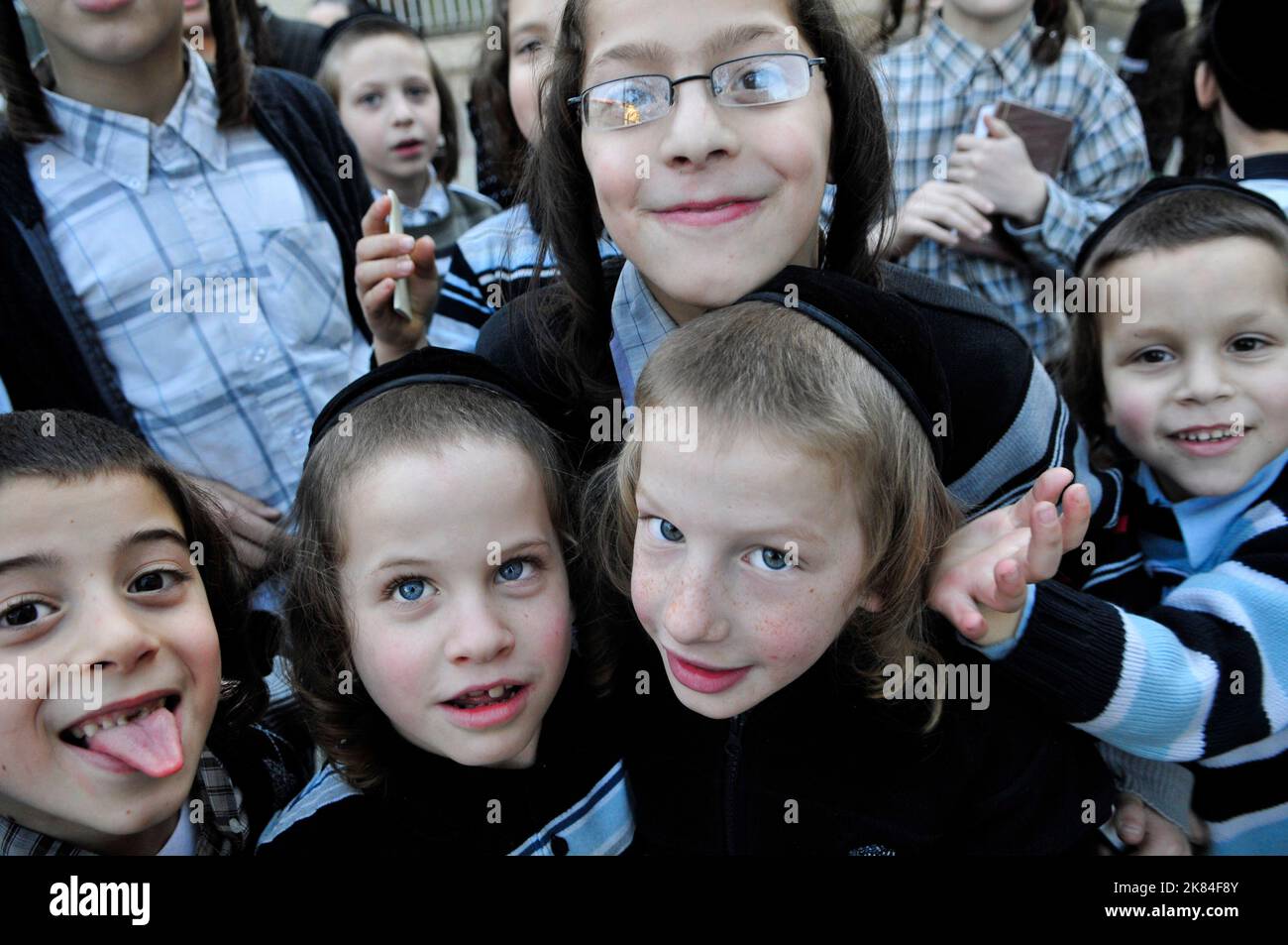 Cheerful & happy. Orthodox Jewish boys having fun in the courtyard of ...