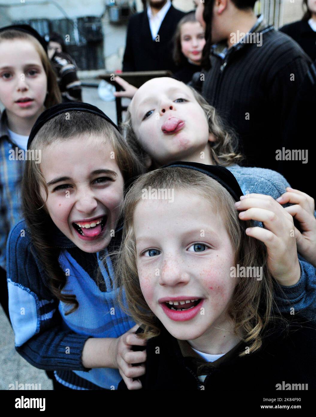 Cheerful & happy. Orthodox Jewish boys having fun in the courtyard of ...