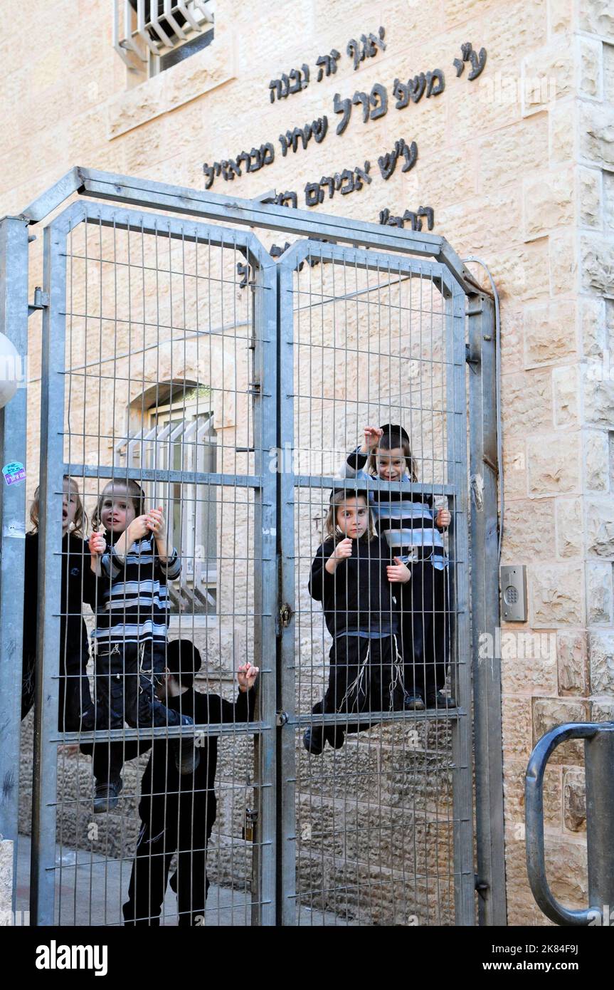 Cheerful & happy. Orthodox Jewish boys having fun in the courtyard of ...