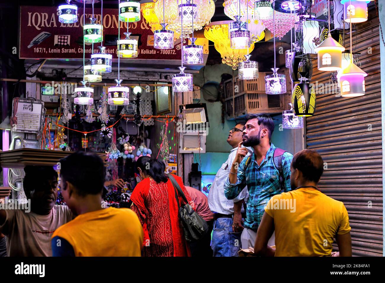 Customers look at lanterns and Diwali decorations on display at a shop ...