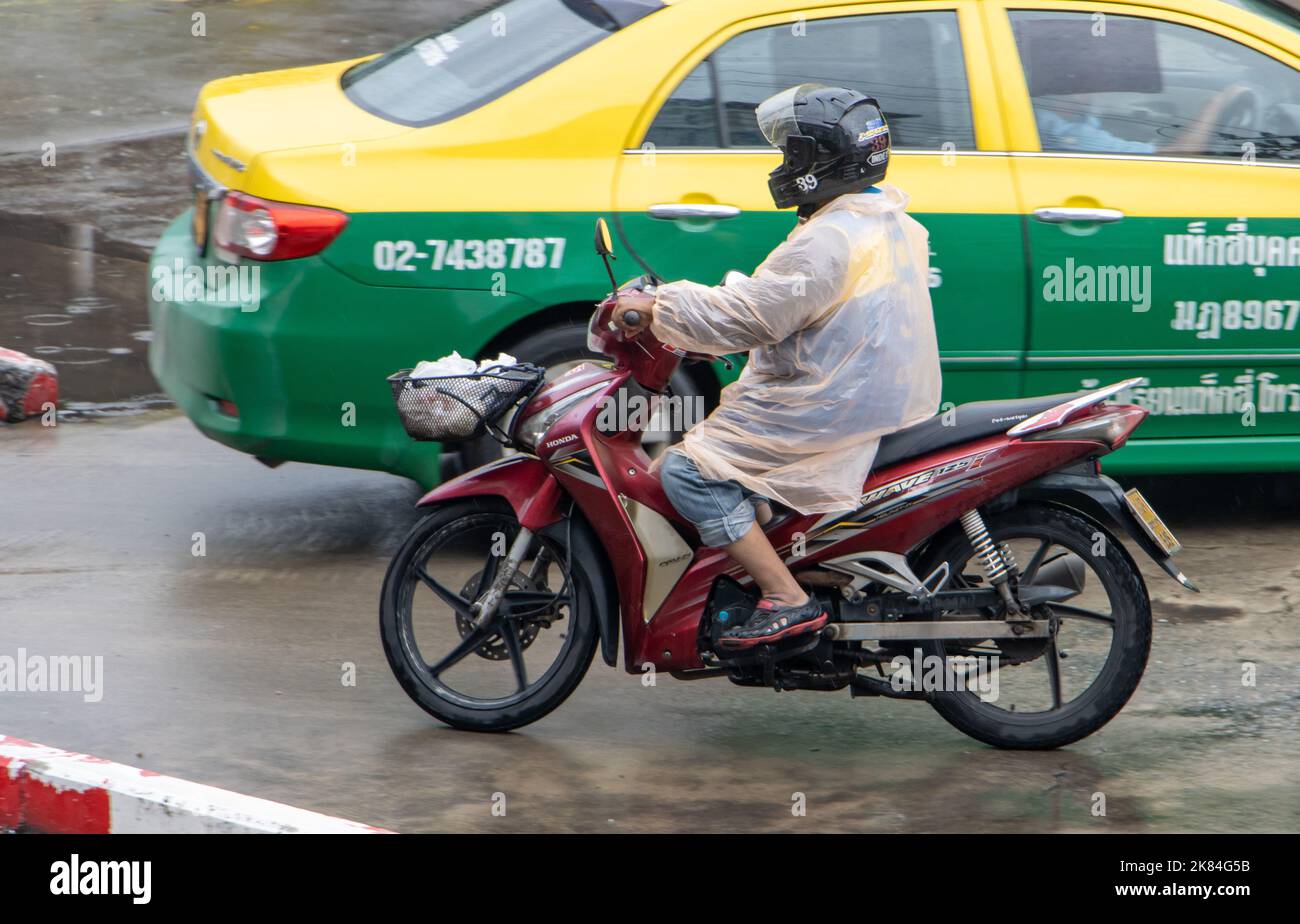 SAMUT PRAKAN, THAILAND, SEP 26 2022, A taxi driver on a motorbike ...