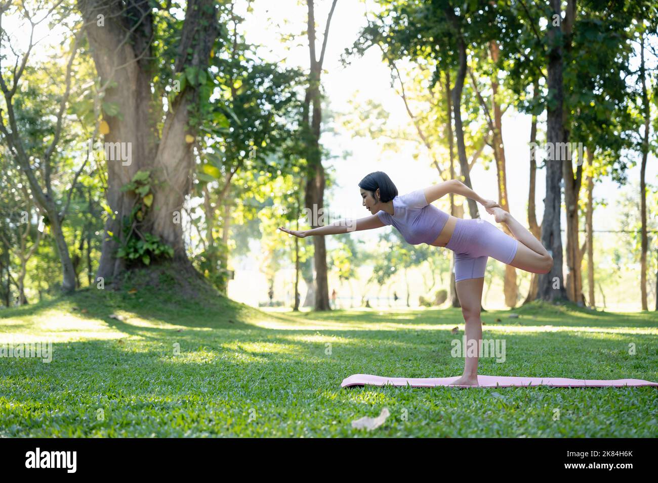 Attractive Young Asian Woman Practice Yoga Exercise In The Park