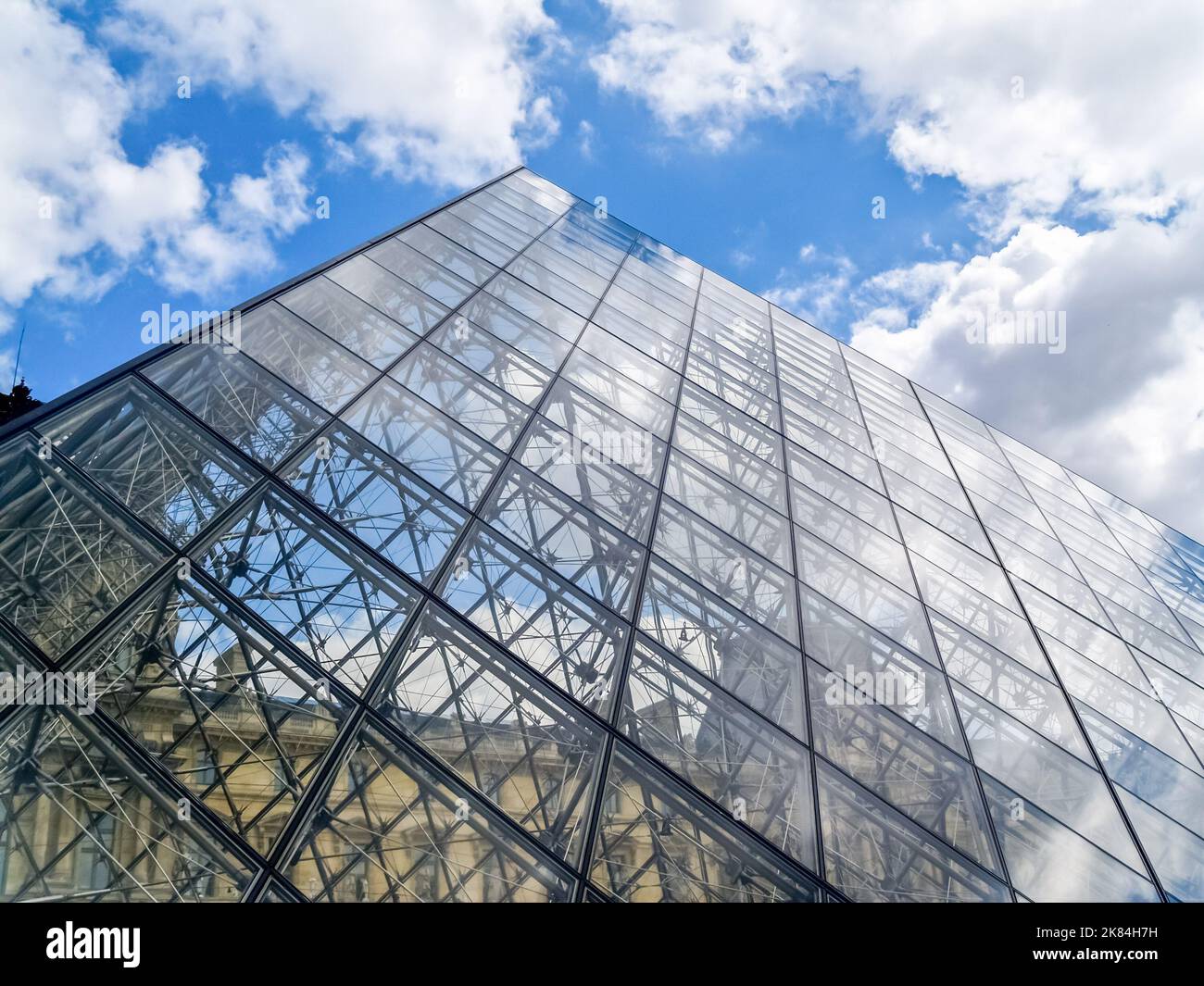 Steel frame and glass panes of Louvre pyramid towering skyward in Paris ...