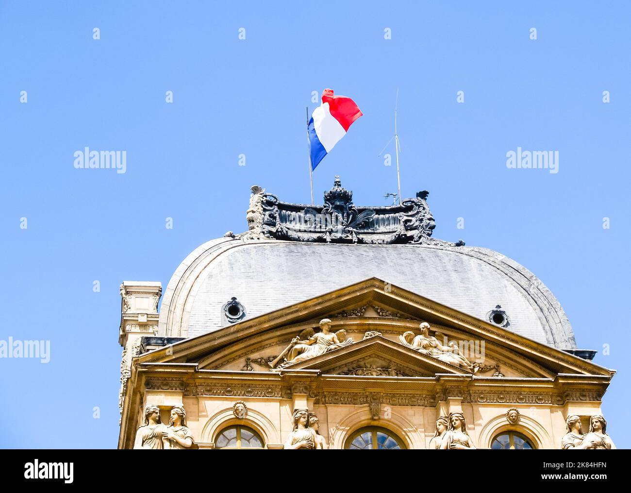Flag of France over historic building in Louvre Museum with intricate ...