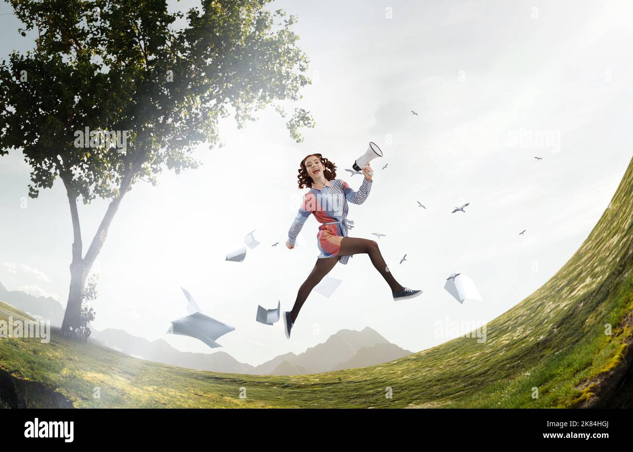 Young businesswoman yelling over megaphone Stock Photo - Alamy