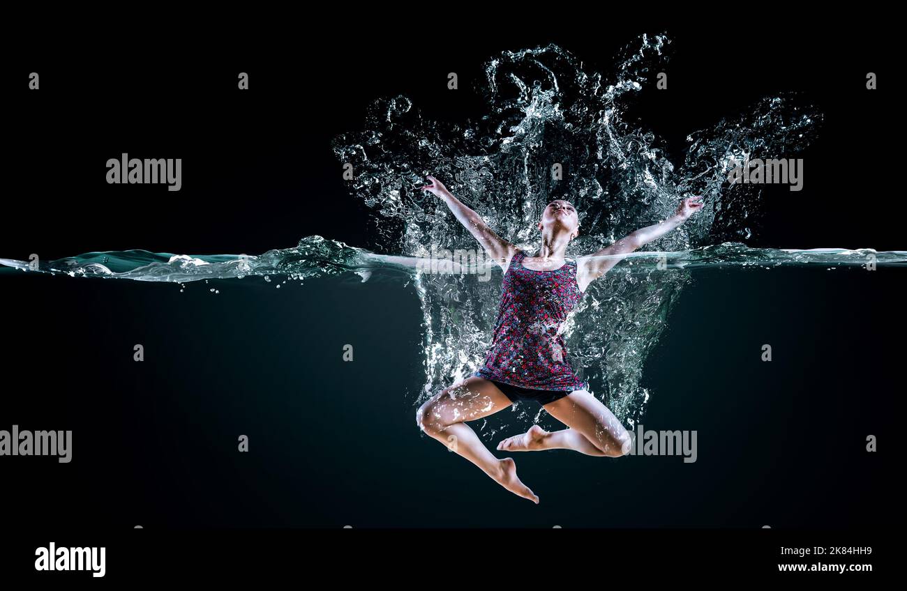 Professional woman swimmer on a wave Stock Photo - Alamy