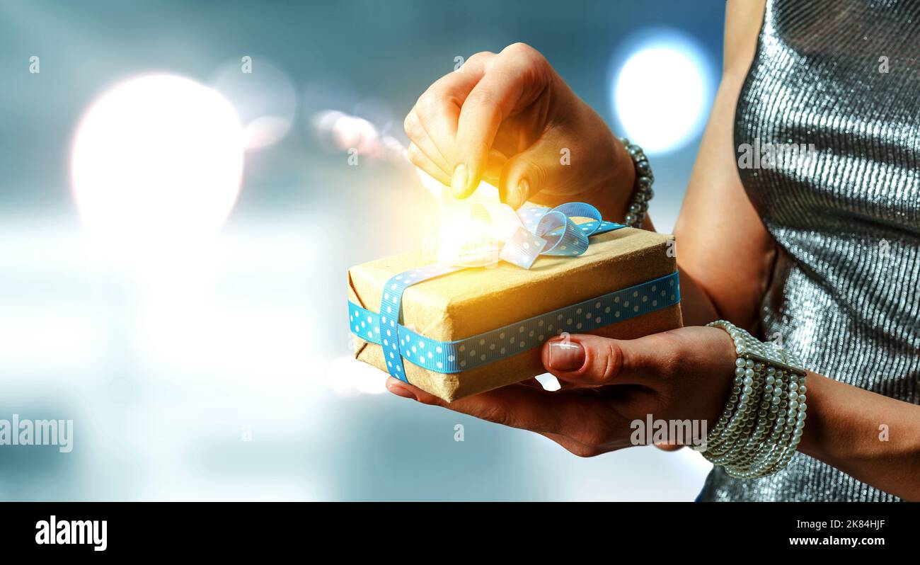 Closeup hands giving surprise gift box Stock Photo - Alamy