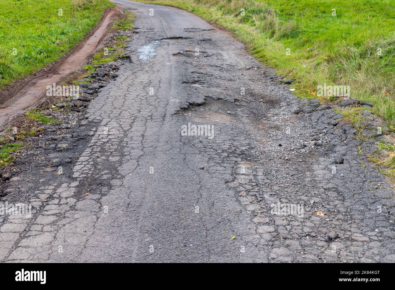 Old cracked country road with potholes Stock Photo - Alamy