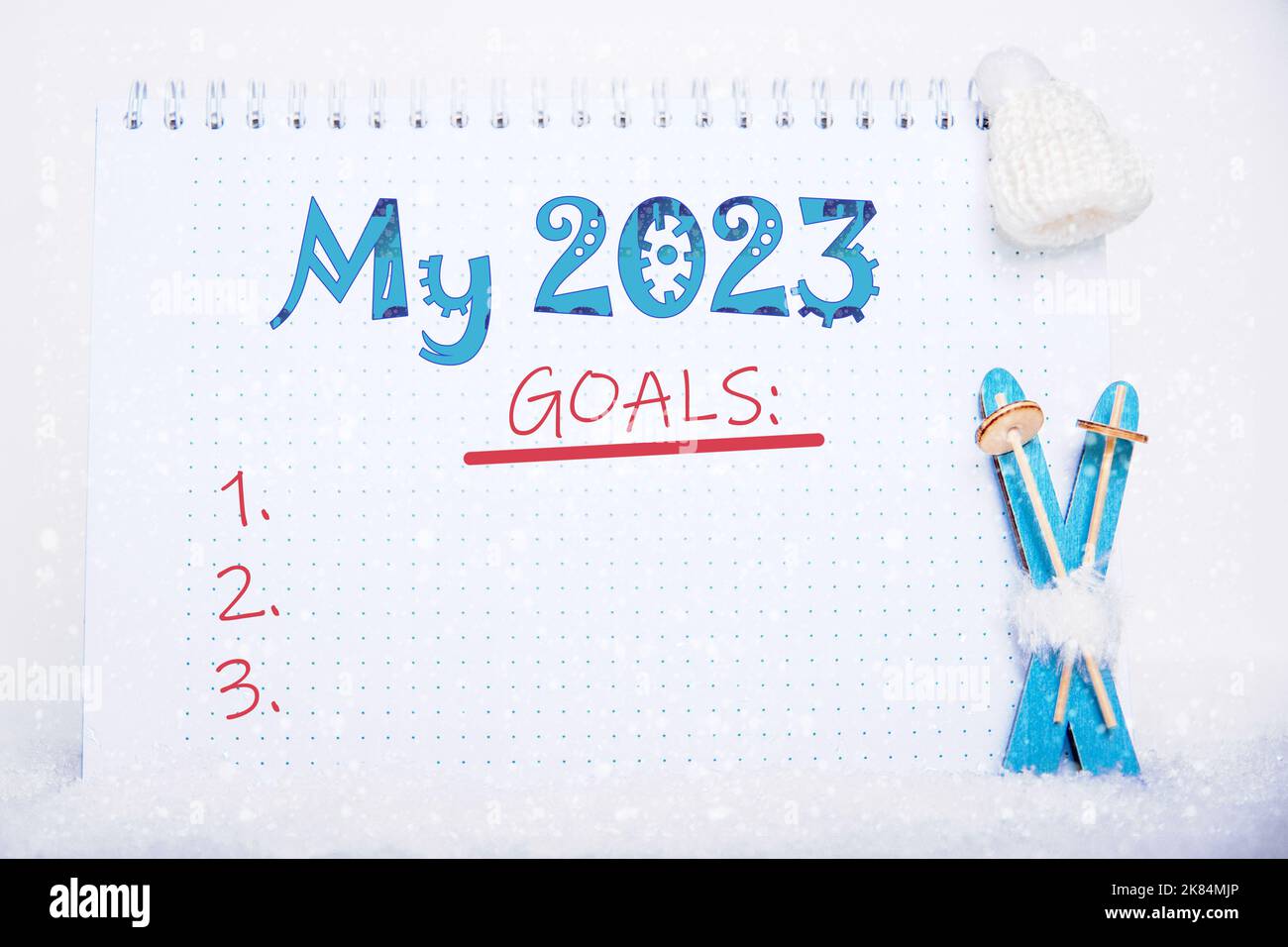 Goals list for New Year Holiday. Bright blue wooden skis and a notebook ...
