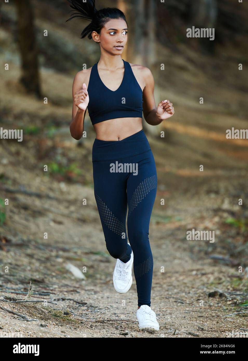 Racing towards a fit, strong and healthy body. a sporty young woman ...