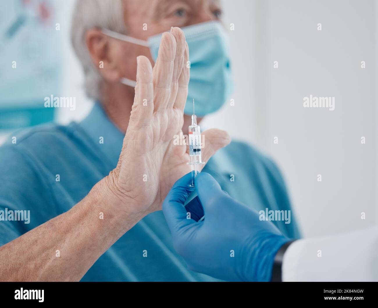 Stop, Im unsure...a senior man gesturing to stop an unrecognizable ...
