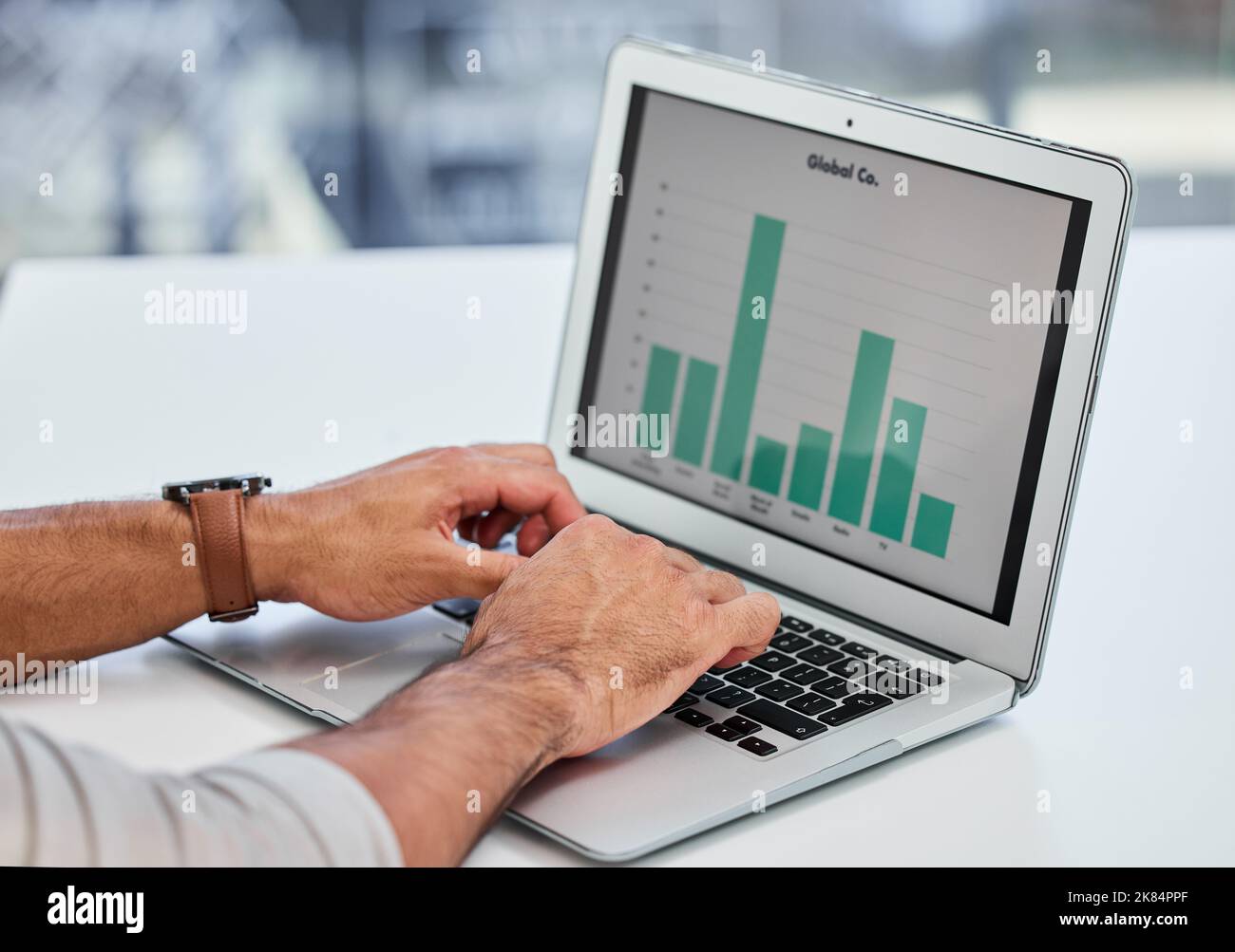 This chart is shaping up well. a businessman typing up charts on his ...