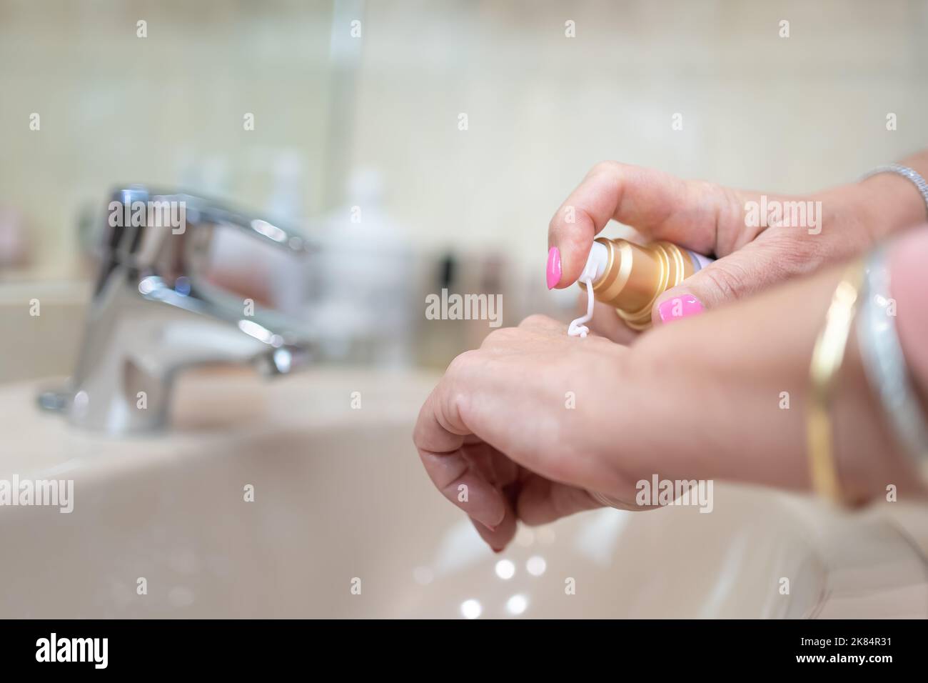 Woman applying in the hands products for the care and improvement of ...