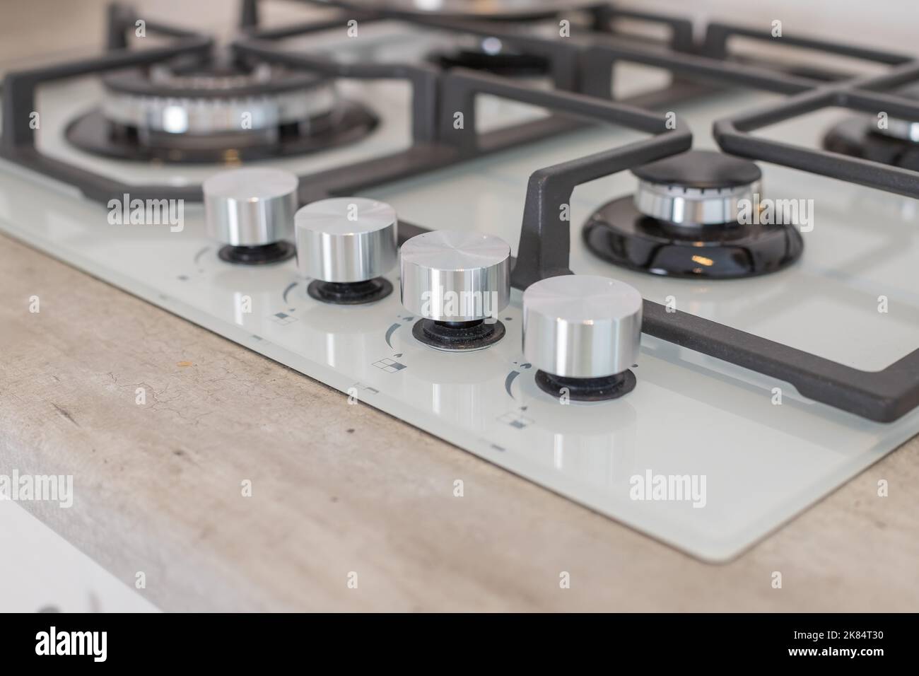 Modern hob gas stove made of tempered white glass using natural gas or ...