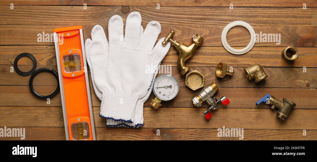 Set of plumber's items on wooden background, top view Stock Photo - Alamy