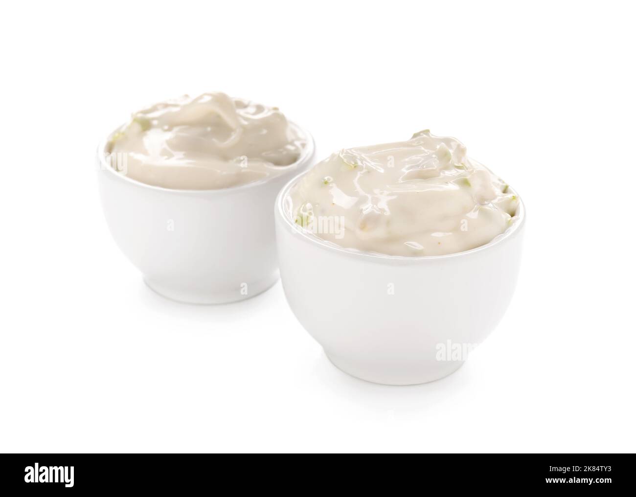 Caesar salad dressing in bowls on white background Stock Photo - Alamy