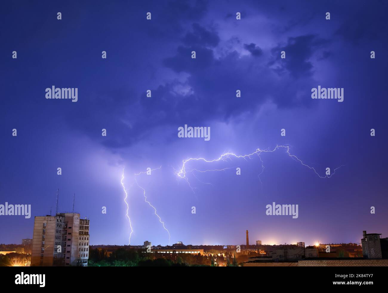 Cityscape with lightning at night Stock Photo - Alamy