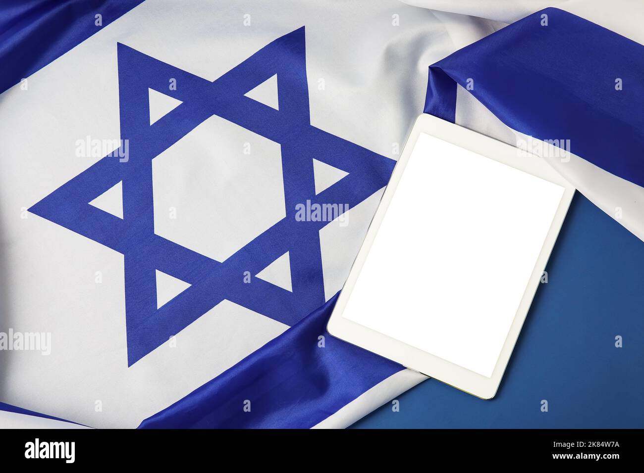 Tablet computer and flag of Israel on color background Stock Photo - Alamy