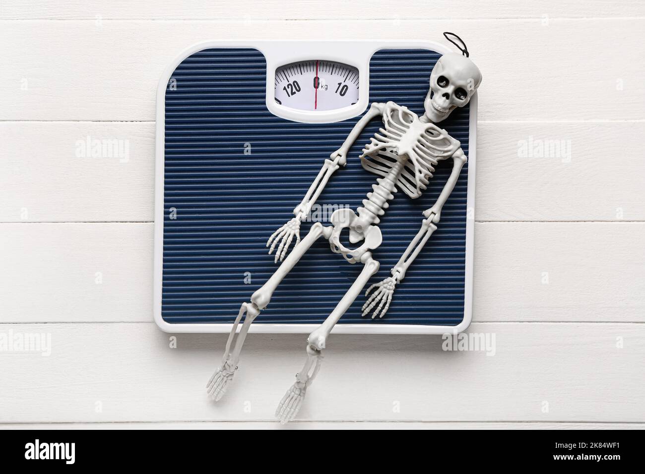 Scales and skeleton on white wooden background. Anorexia concept Stock ...