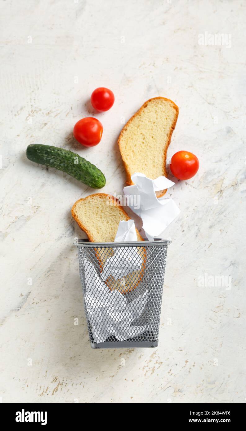 Trash can with food on light background. Anorexia concept Stock Photo ...