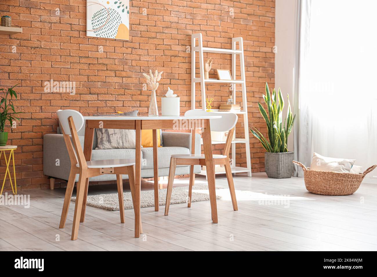 Comfortable dining table in room with modern furniture Stock Photo - Alamy
