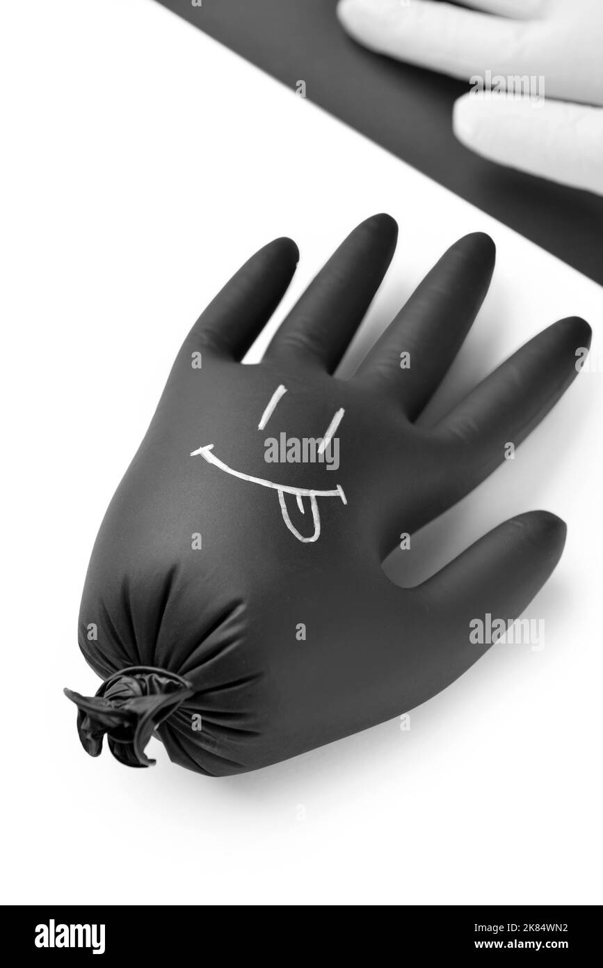 Inflated medical glove with happy smile drawing on white background ...