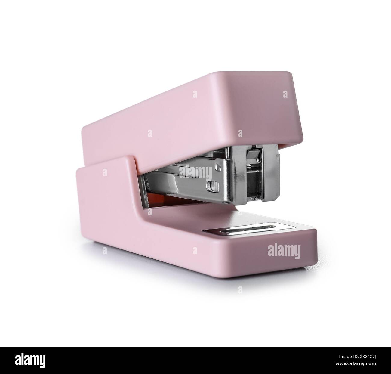 Modern pink stapler on white background Stock Photo - Alamy