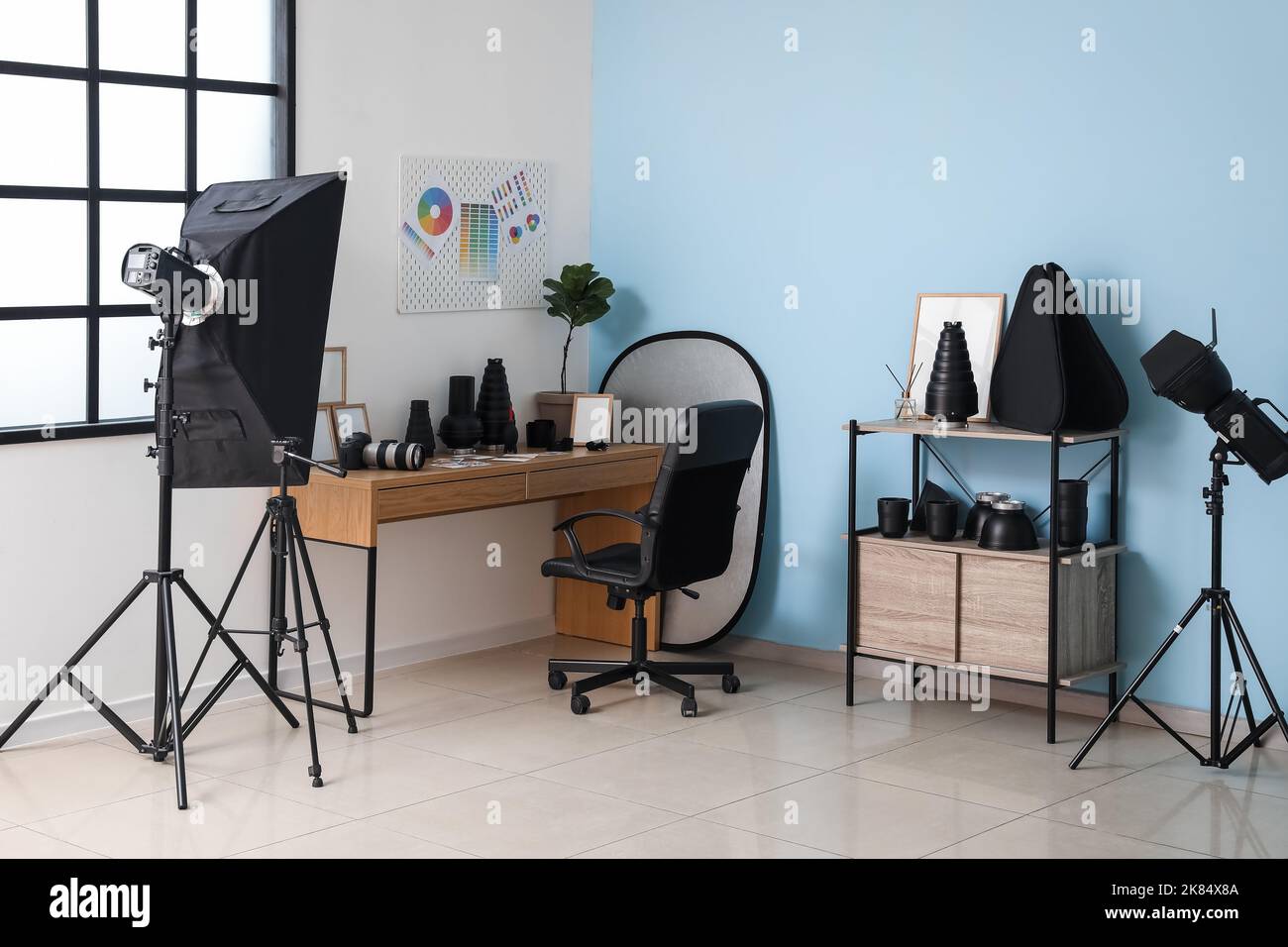 Interior of modern office with photographer's workplace, shelving unit ...
