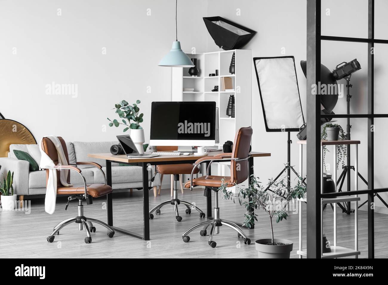 Interior of modern studio with photographer's workplace and ...