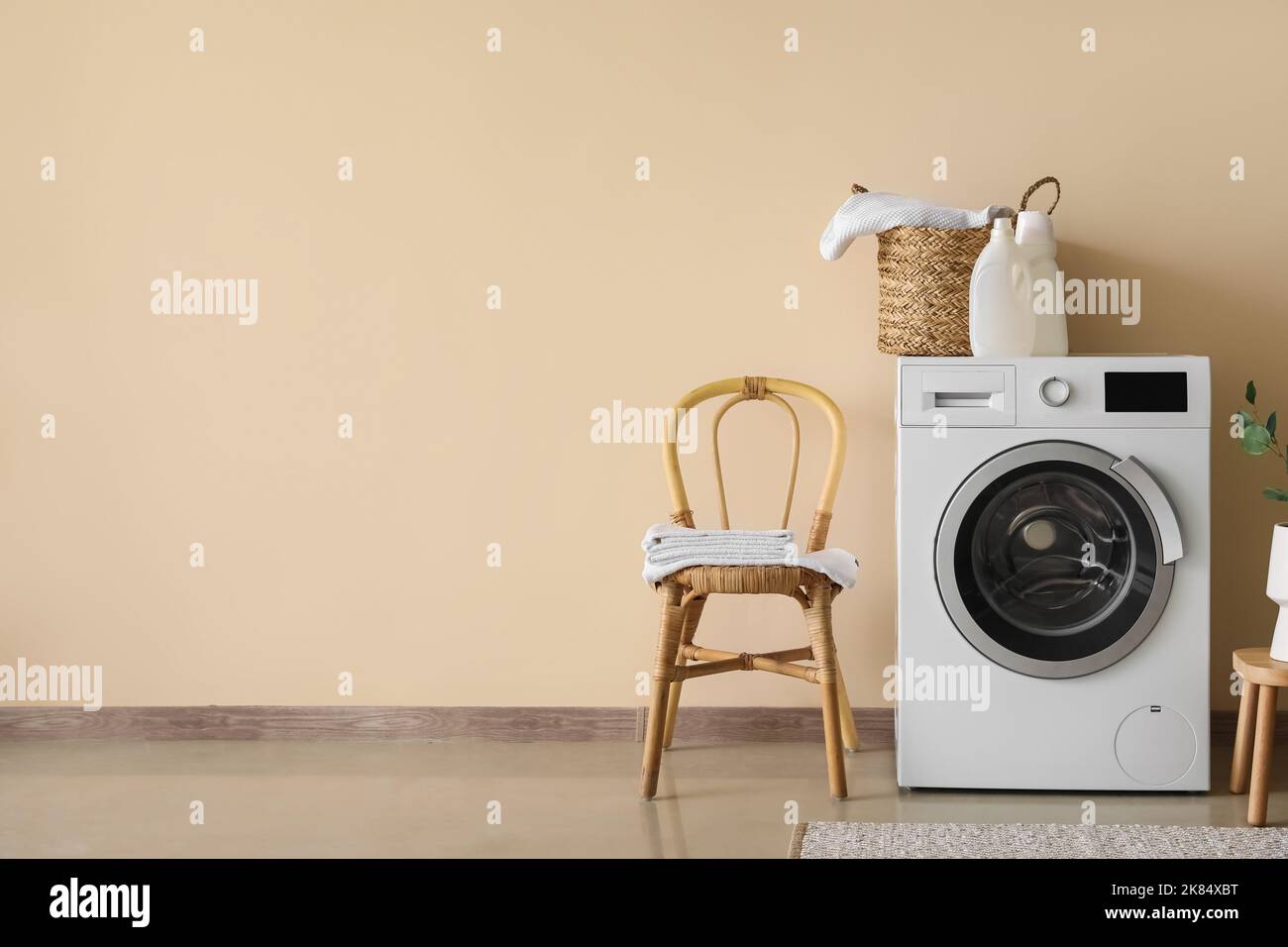 Interior of laundry room with washing machine, chair and stool Stock ...